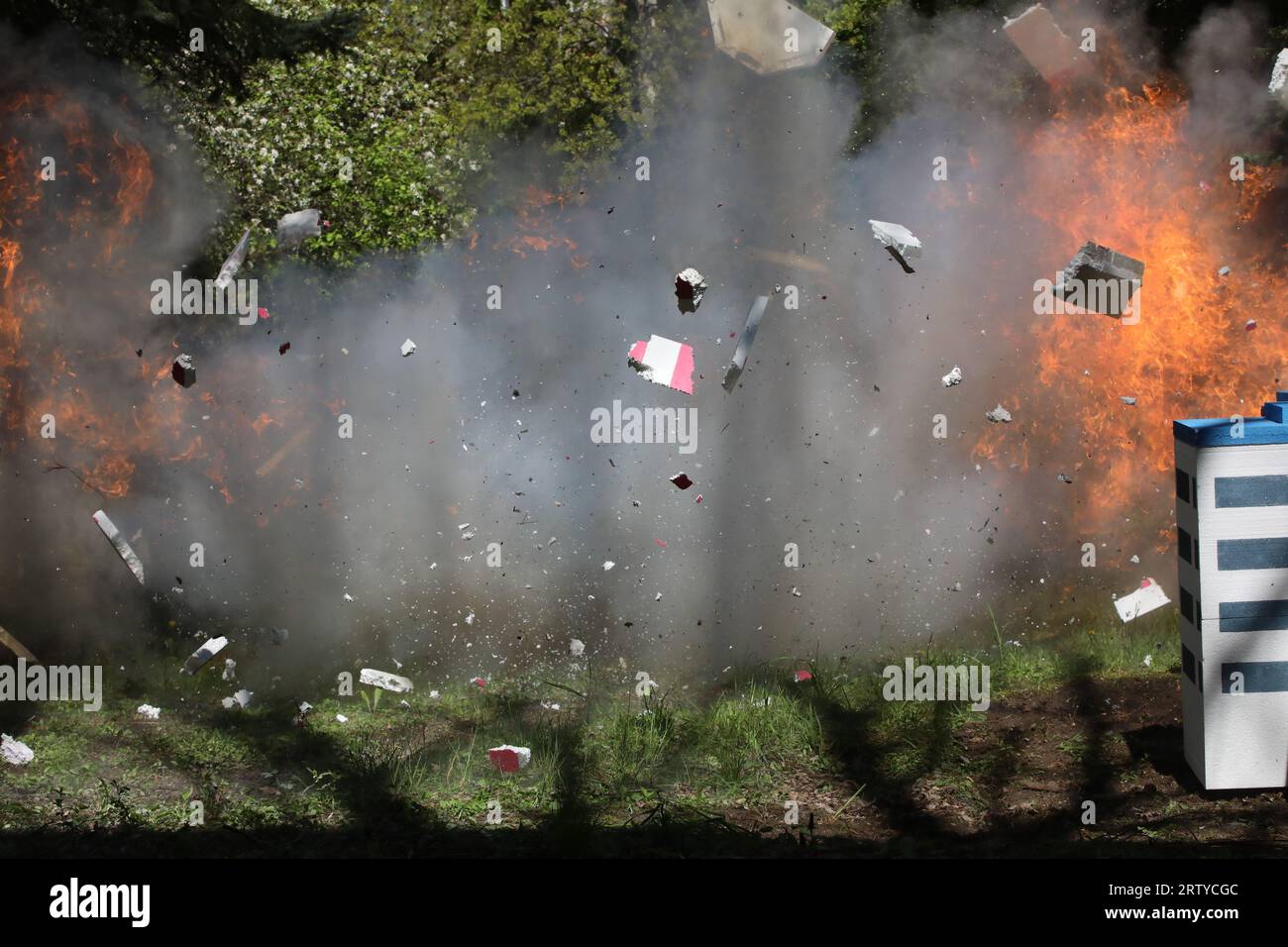 Fire from a large explosion between green trees Stock Photo - Alamy