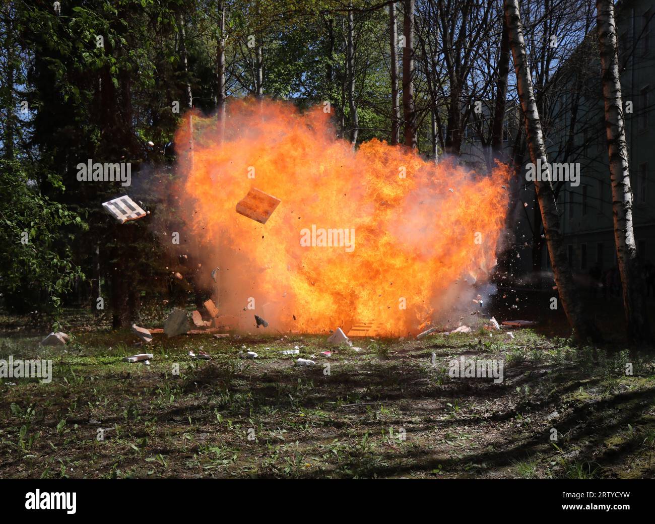 Fire from a large explosion between green trees Stock Photo - Alamy