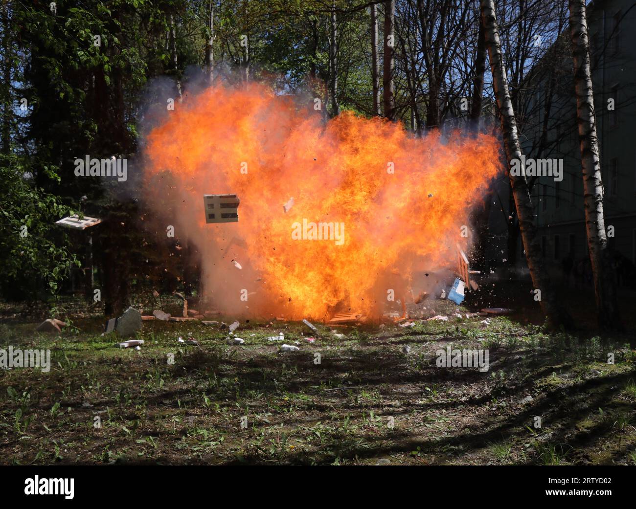 Fire from a large explosion between green trees Stock Photo - Alamy