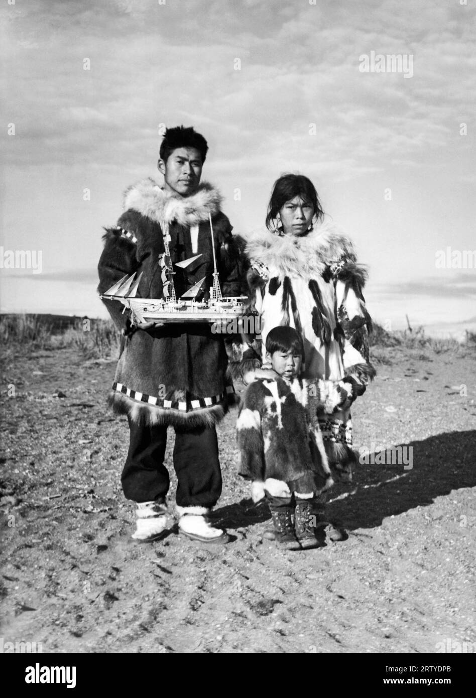 Alaska, c. 1930 An Eskimo family with mother, child, and father who his ...