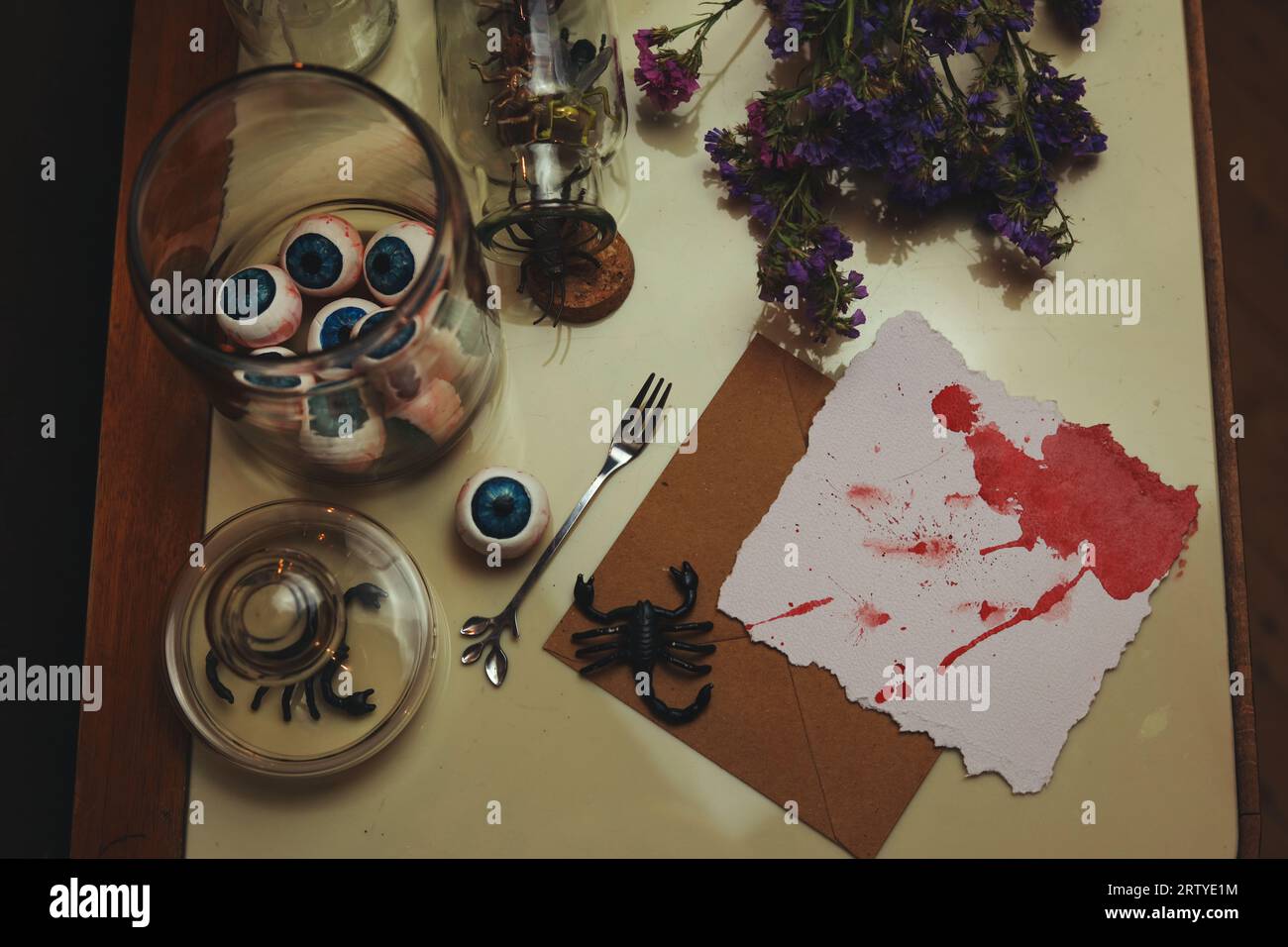 halloween still life with a blank bloody card, eyeballs, scorpions ...