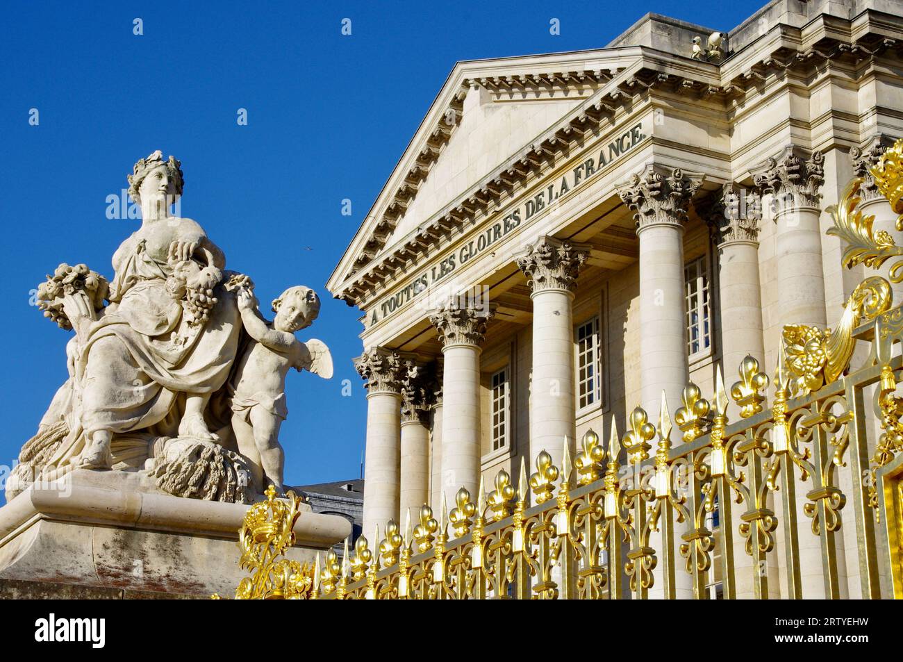 The beautiful Golden Gates outside The Palace of Versailles, under a ...