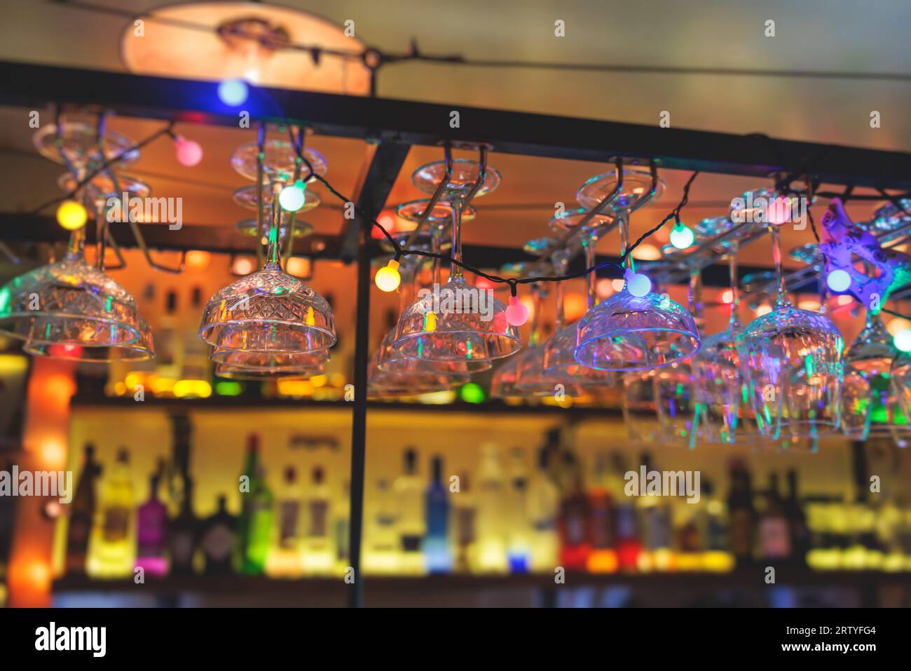 Bar interior details, glasses for wine and different alcohol cocktail ...