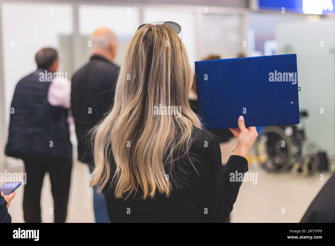 Meeting at the airport, person holding a placard card sign with welcome ...