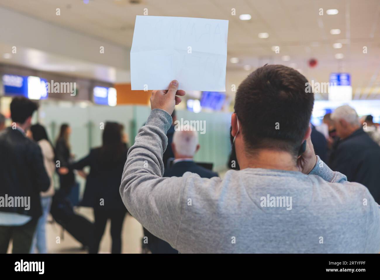 Meeting at the airport, person holding a placard card sign with welcome ...