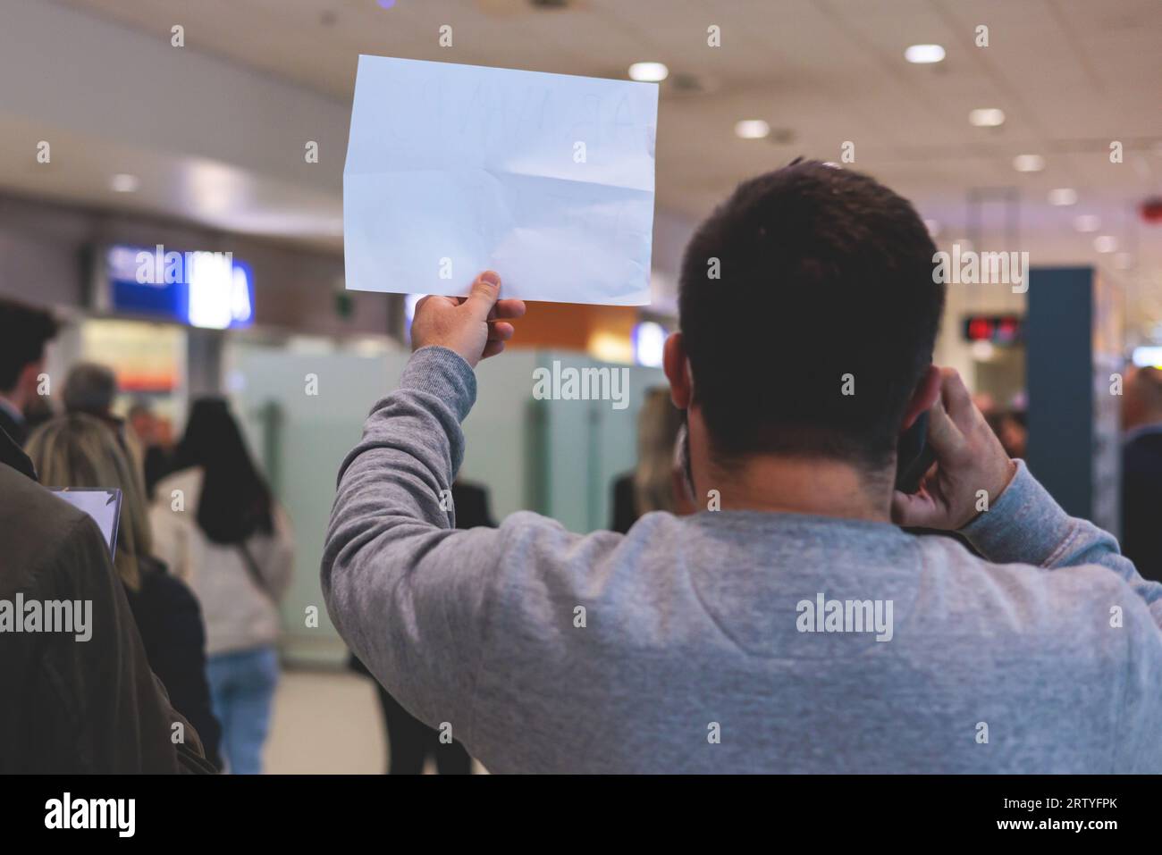 Airport arrival greeting placard hi-res stock photography and images ...