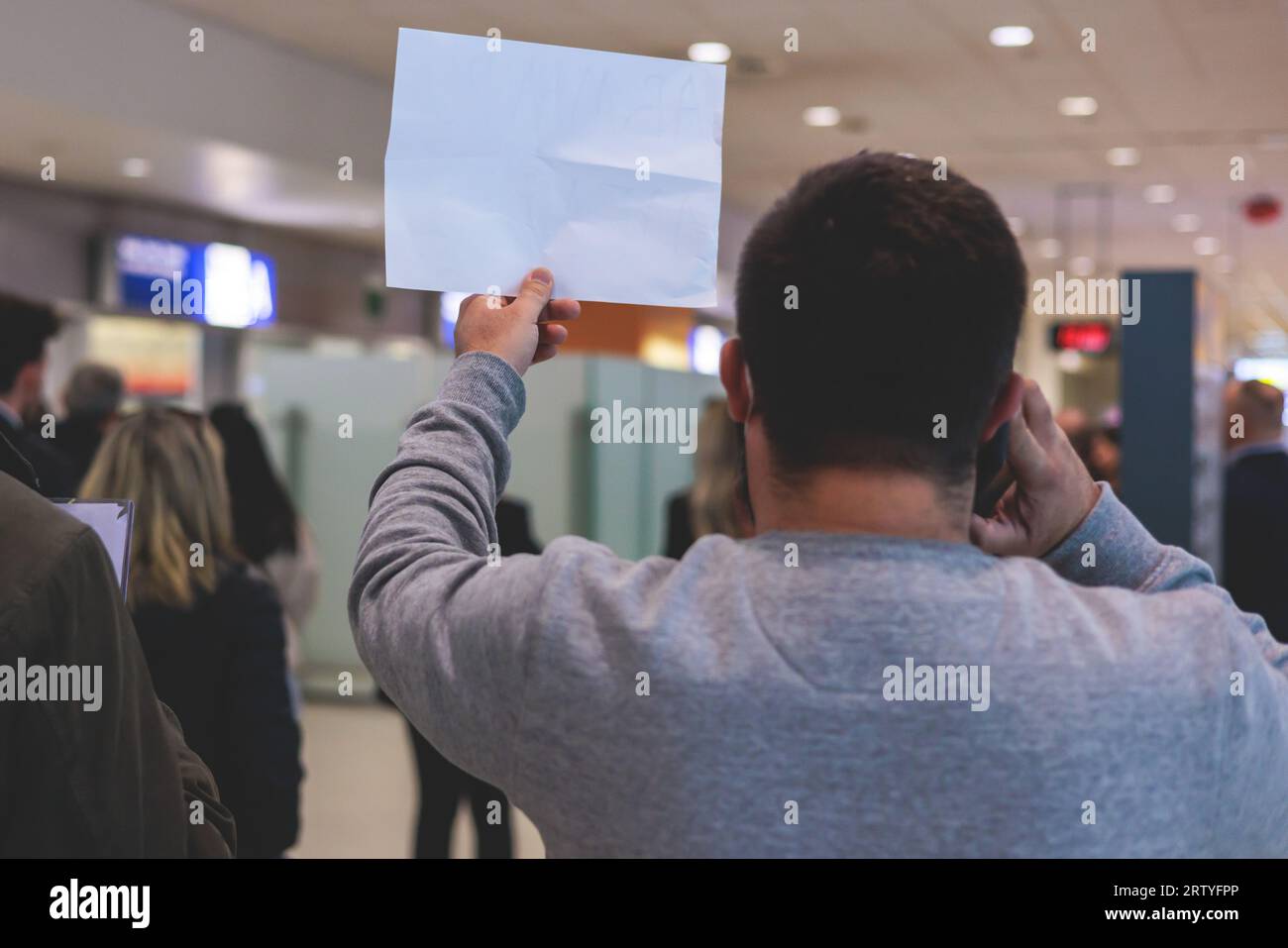 Meeting at the airport, person holding a placard card sign with welcome ...