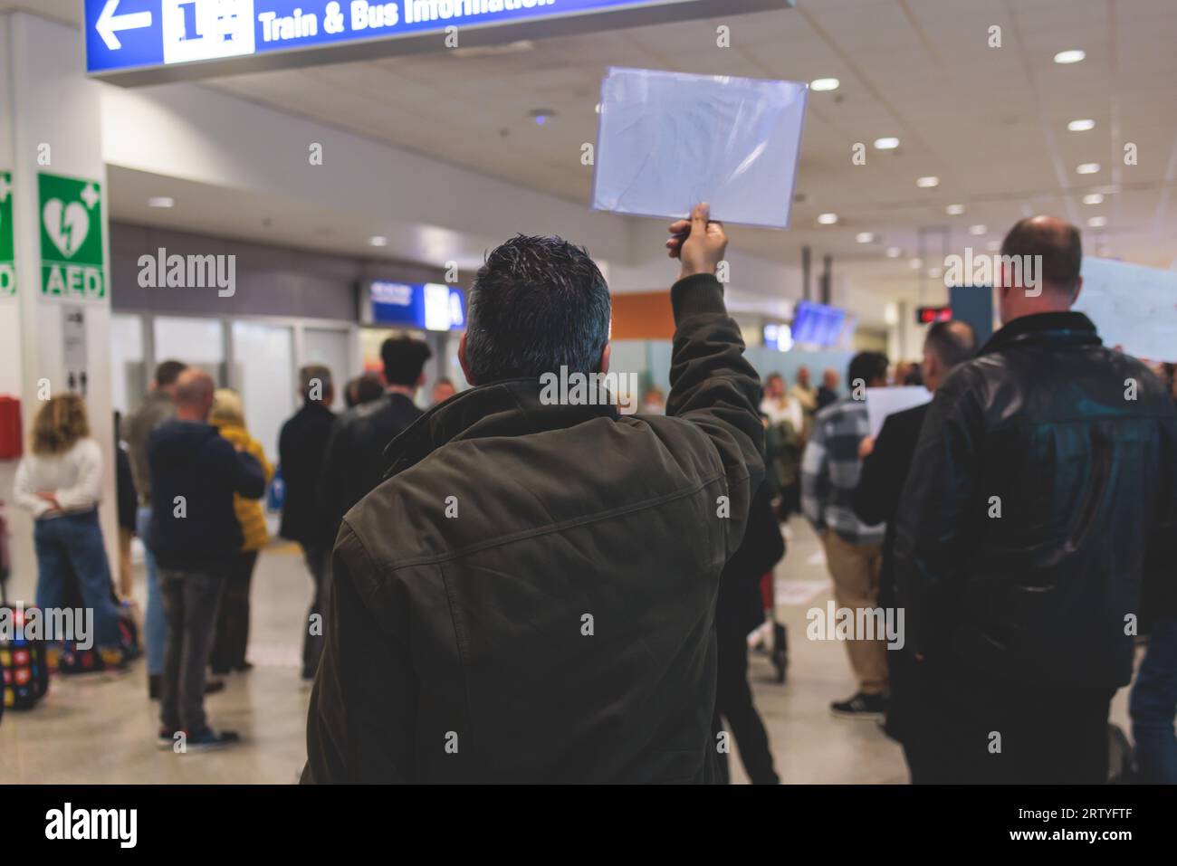 Meeting at the airport, person holding a placard card sign with welcome ...