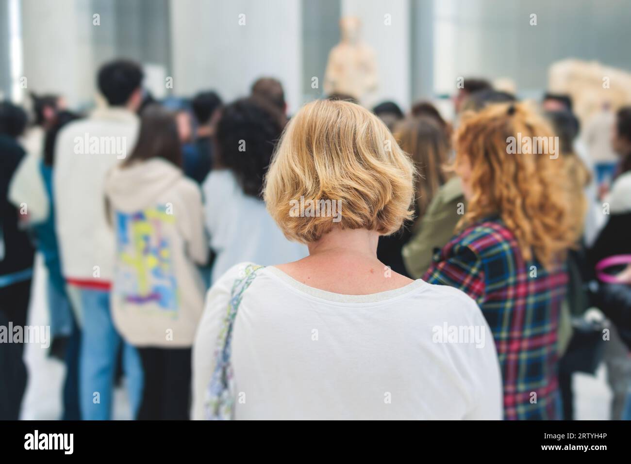 Group of students on excursion visit gallery museum with tour guide, a ...