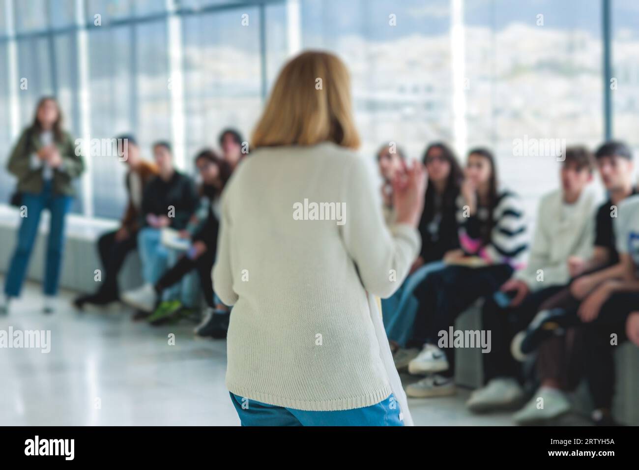 Group of students on excursion visit gallery museum with tour guide, a ...