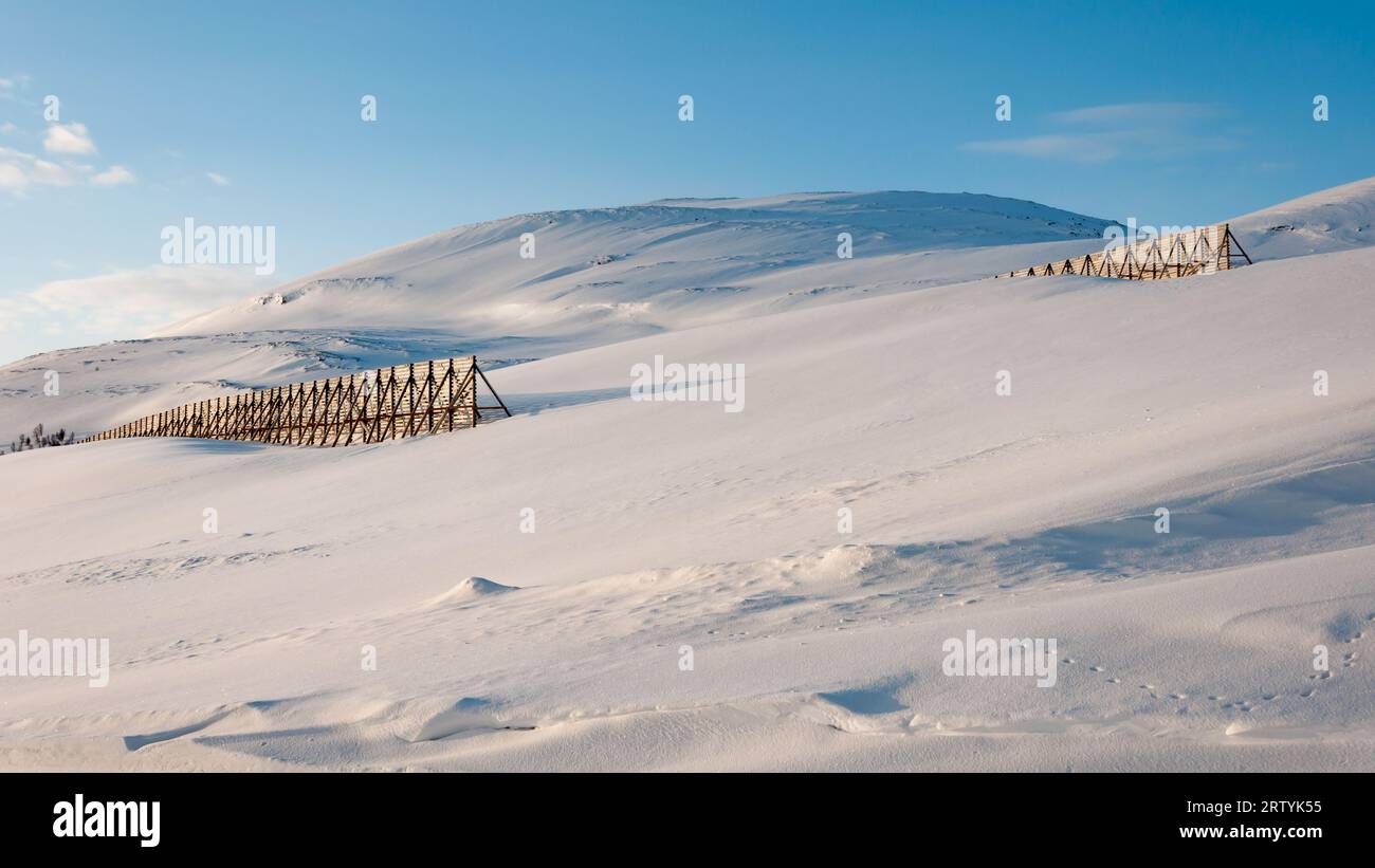 Snow covered mountains in arctic Norway with protective fences to block ...