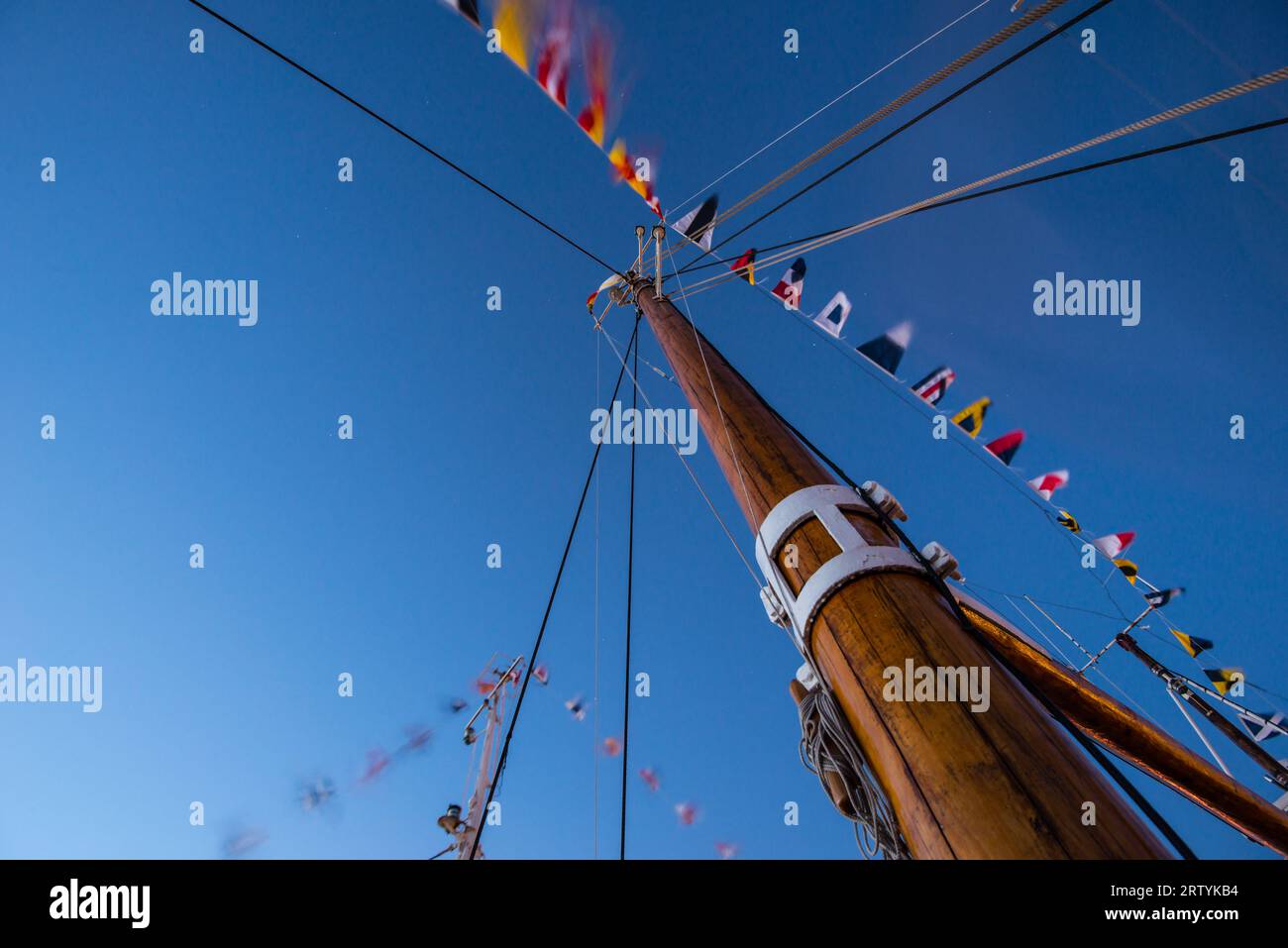 Looking up a ship mast with signal flags Stock Photo - Alamy