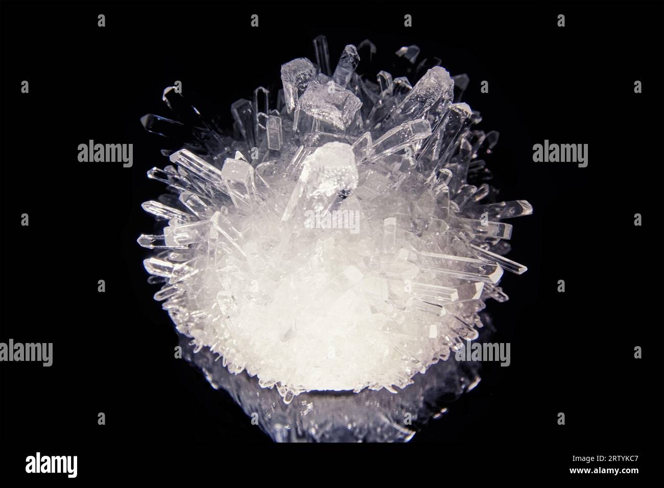 Closeup view of big sharp shiny quartz gem isolated on black background ...