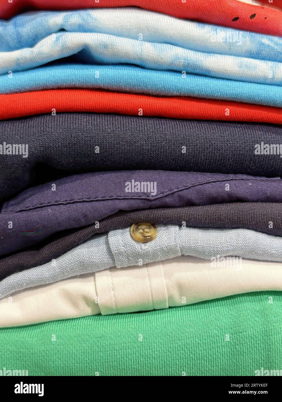 Textured view of stack of new clothes and t-shirts in the shop ...
