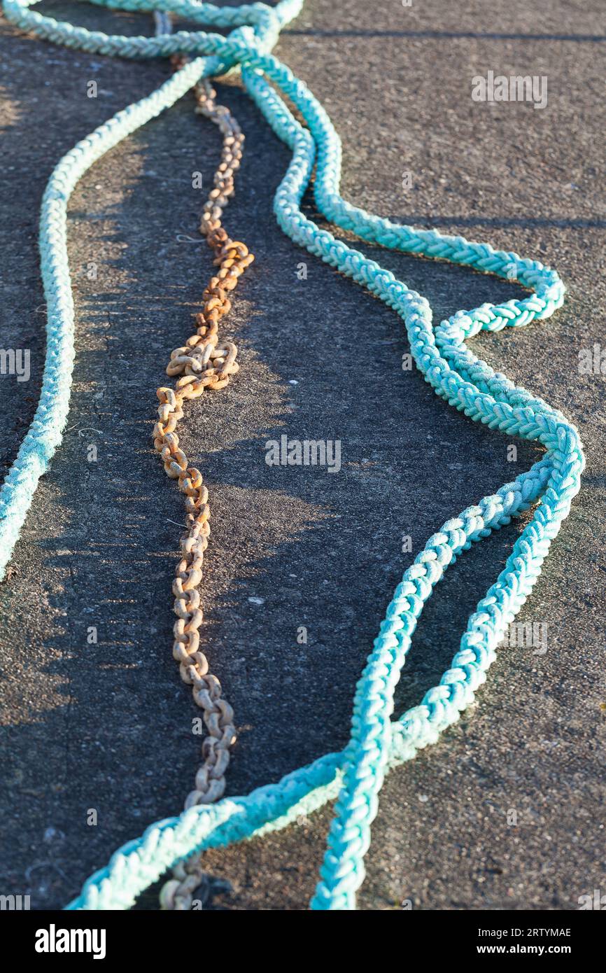 Mooring ropes and chain on the port quay, close-up Stock Photo - Alamy