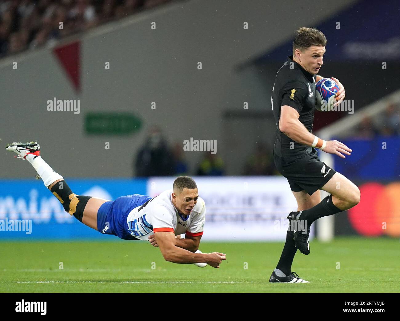 New Zealand's Beauden Barrett (right) evades Namibia's Cliven Loubser ...