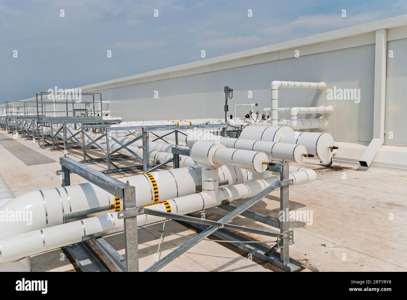Insulated piping on the roof of an ammonia cycle industrial ...