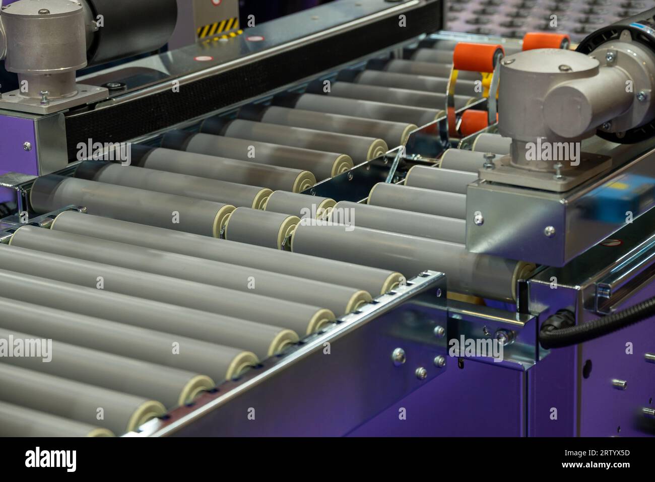 Close-up of an industrial conveyor with rollers for moving product ...