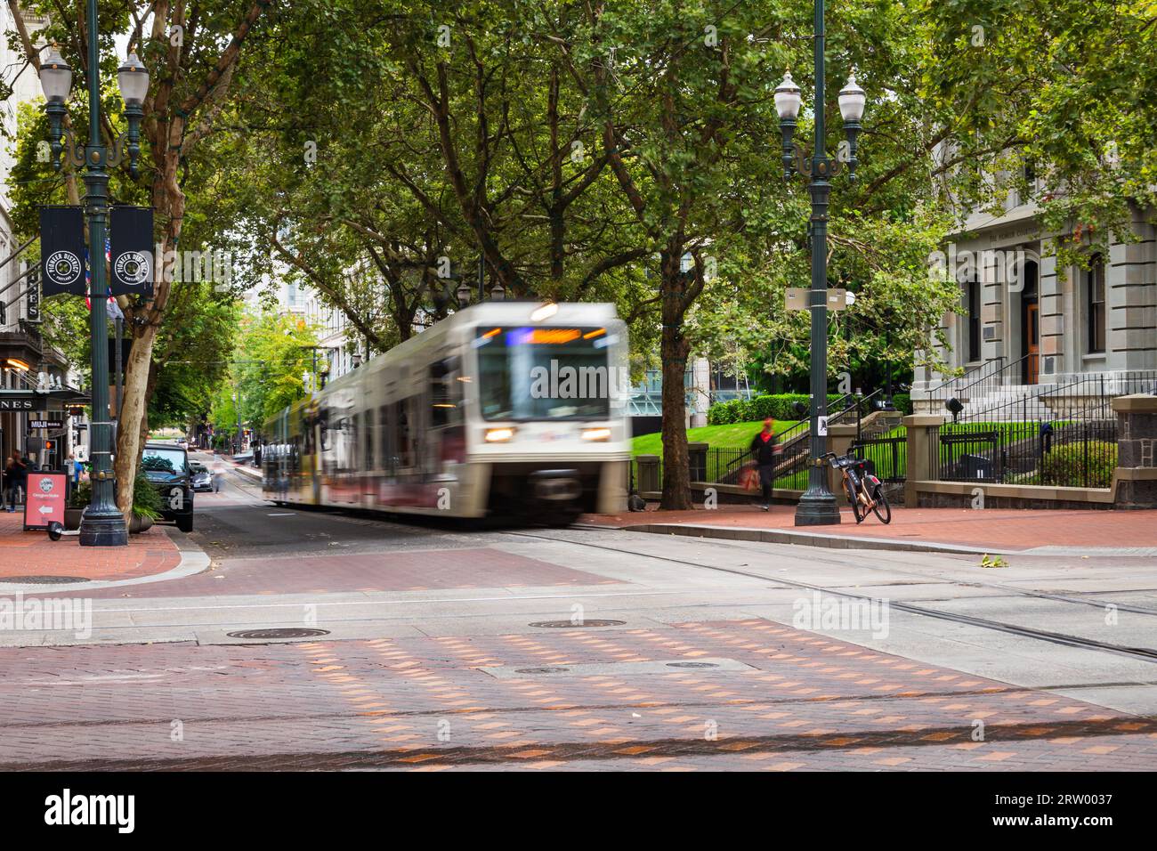 Trimet MAX train passing by the Pioneer Courthouse in downtown Portland ...