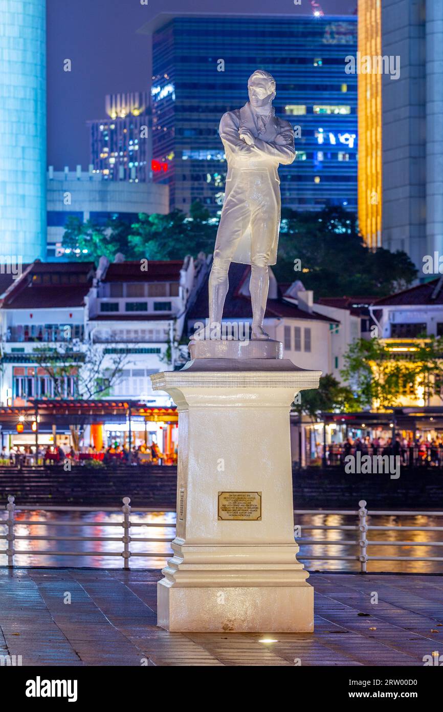 A night view of the statue of Sir Stamford Raffles on the North Bank of the Singapore River ...