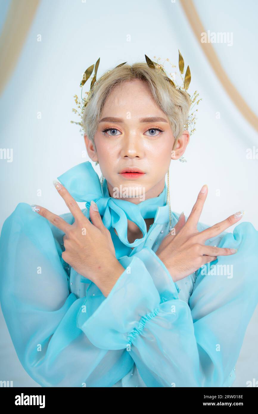 a royal princess in a blue dress posing with her hands very elegantly ...