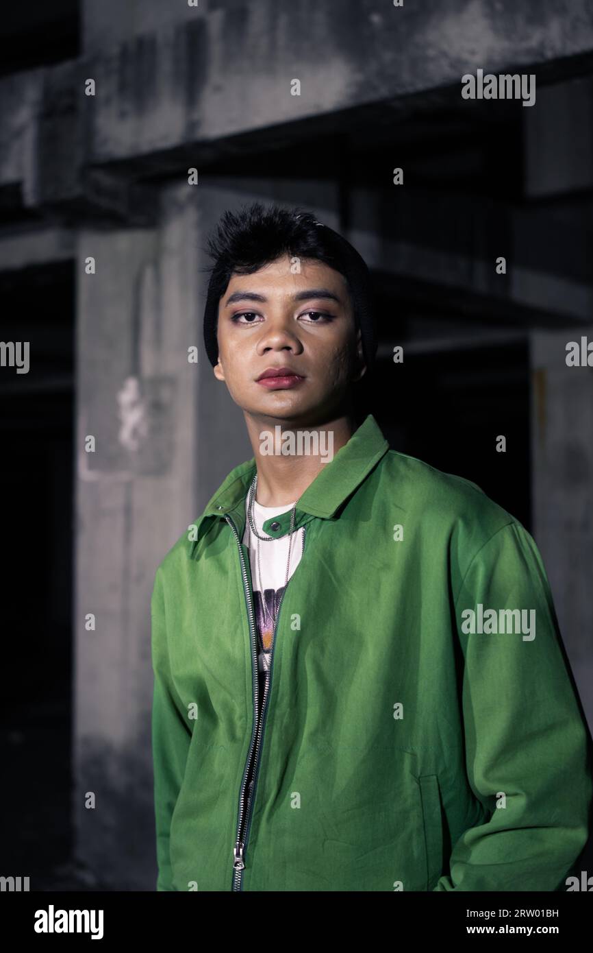 an Asian man is standing in an abandoned building in an eccentric ...