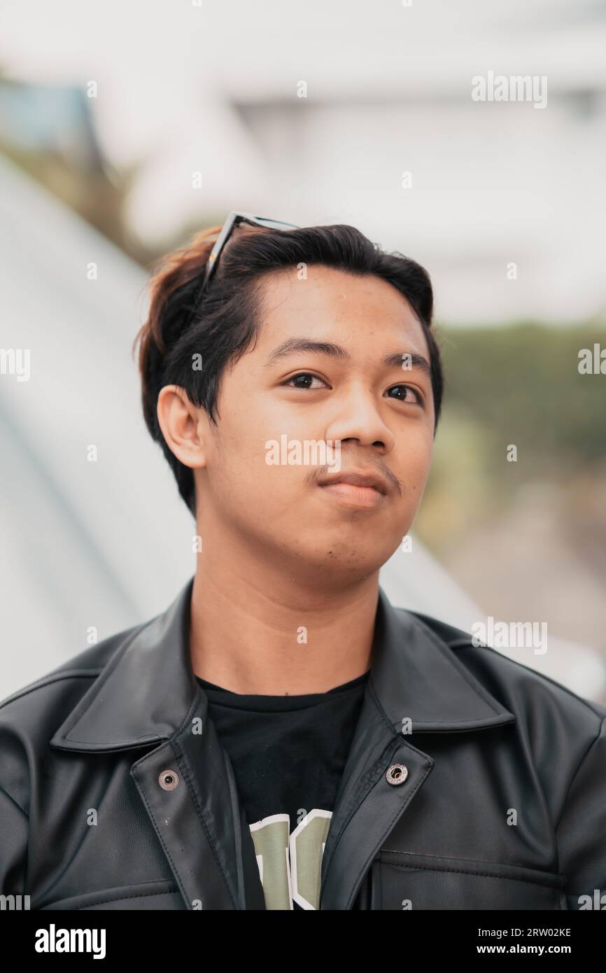 the face of a very silly Asian man with sunglasses on his head while ...