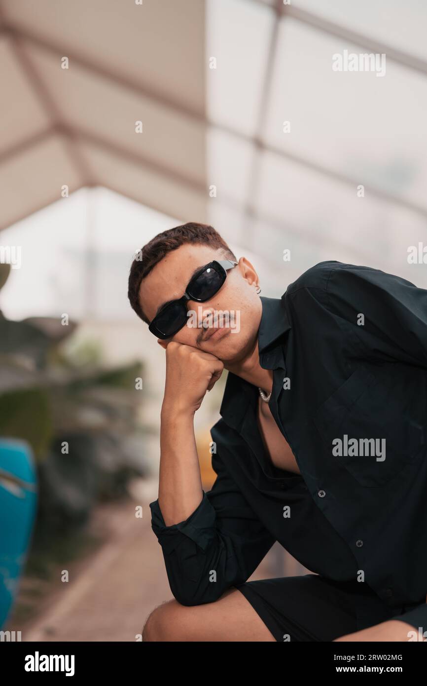 an Asian man with a mustache face wearing a shirt and sunglasses in a ...