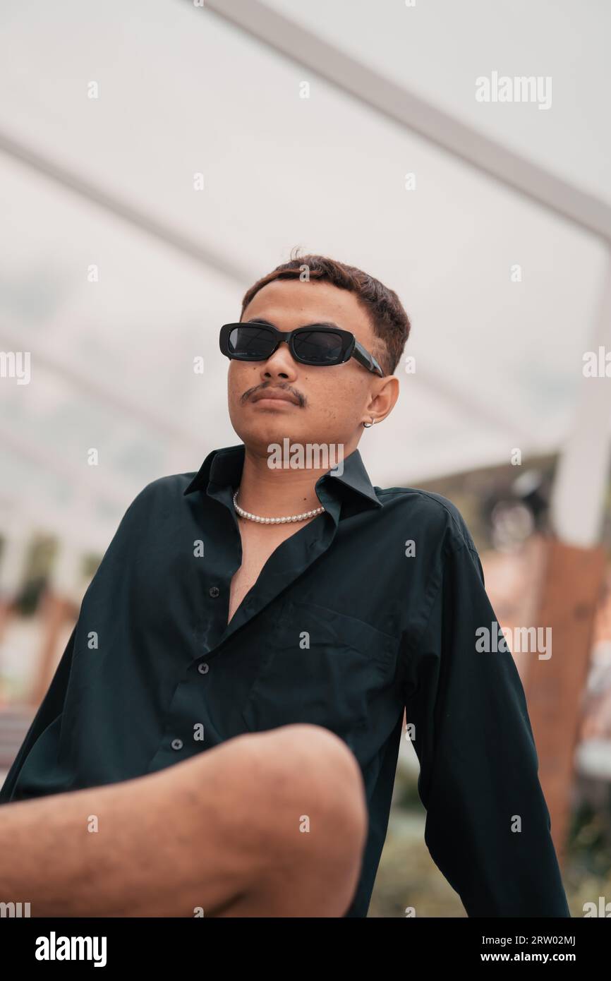 an Asian man with a mustache face wearing a shirt and sunglasses in a ...
