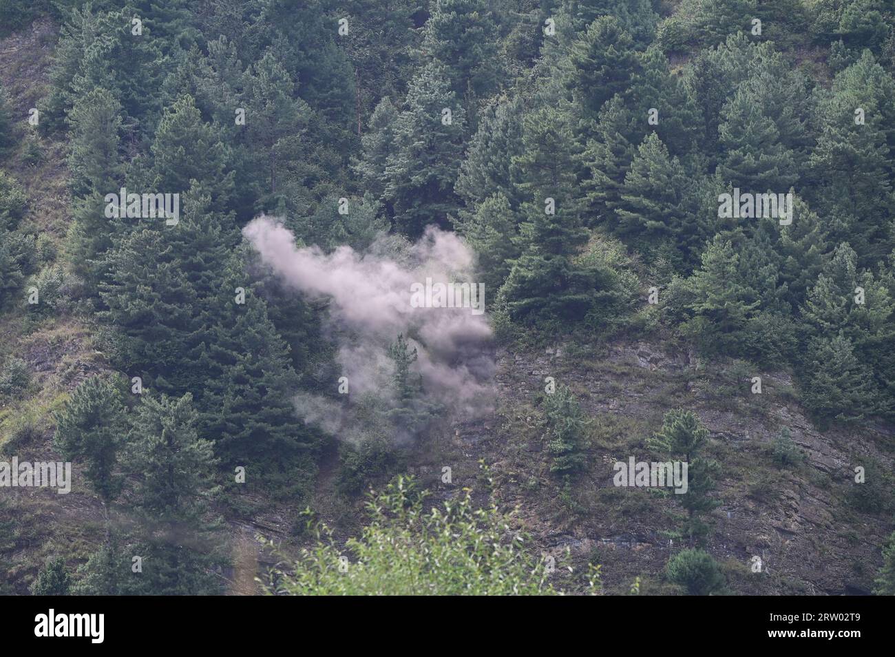ANANTNAG, INDIA - SEPTEMBER 15: Smoke rises from the mountain after ...