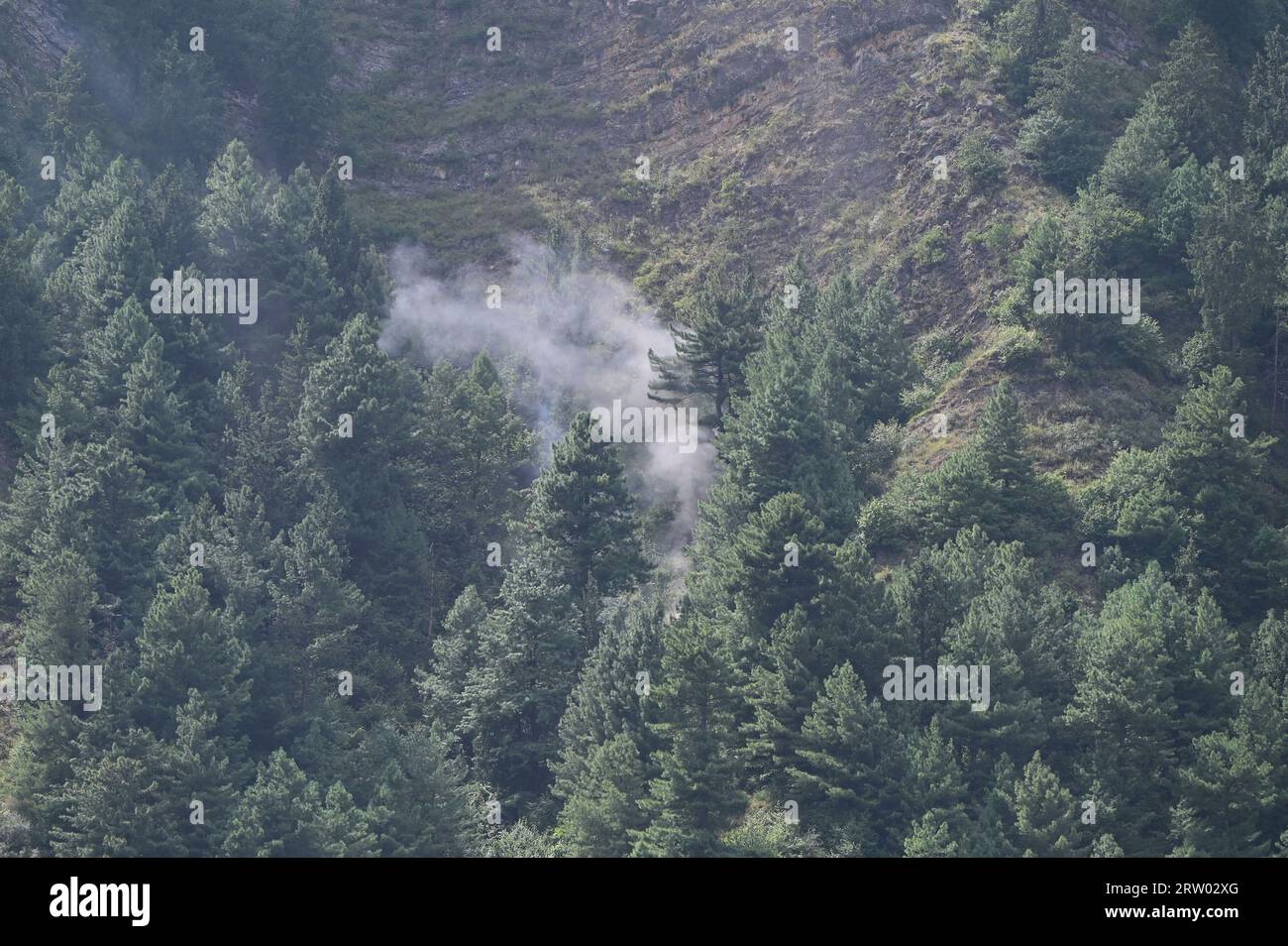 ANANTNAG, INDIA - SEPTEMBER 15: Smoke rises from the mountain after ...