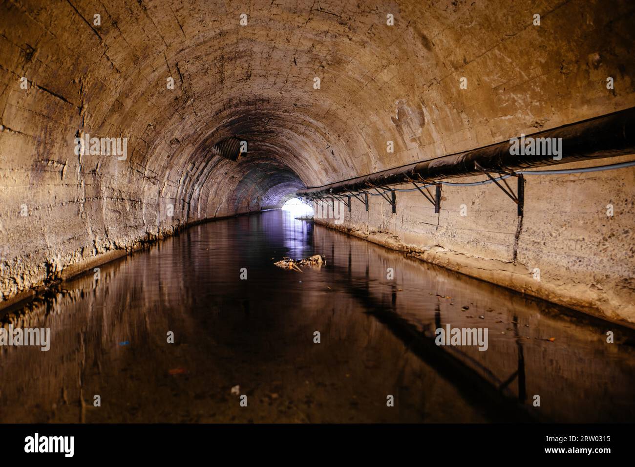 Underground flooded vaulted urban sewer tunnel with dirty sewage Stock ...