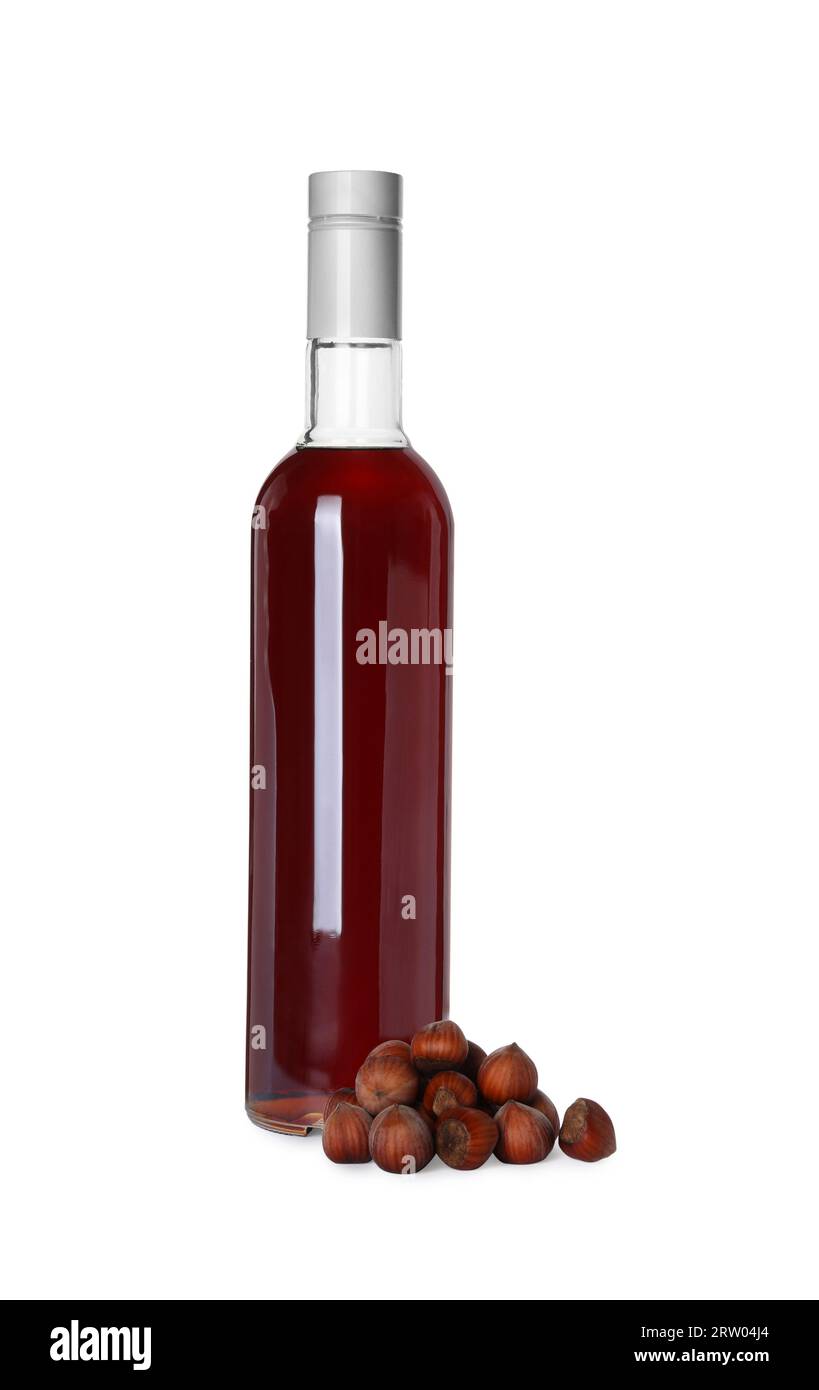 Delicious syrup and hazelnuts on white background Stock Photo - Alamy
