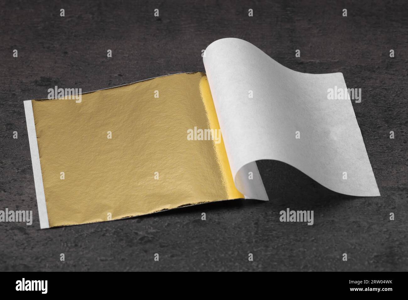 Edible gold leaf sheet on textured table, closeup Stock Photo - Alamy