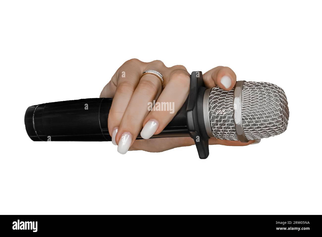 Hand of a young girl with a manicure and a ring holding a microphone on ...
