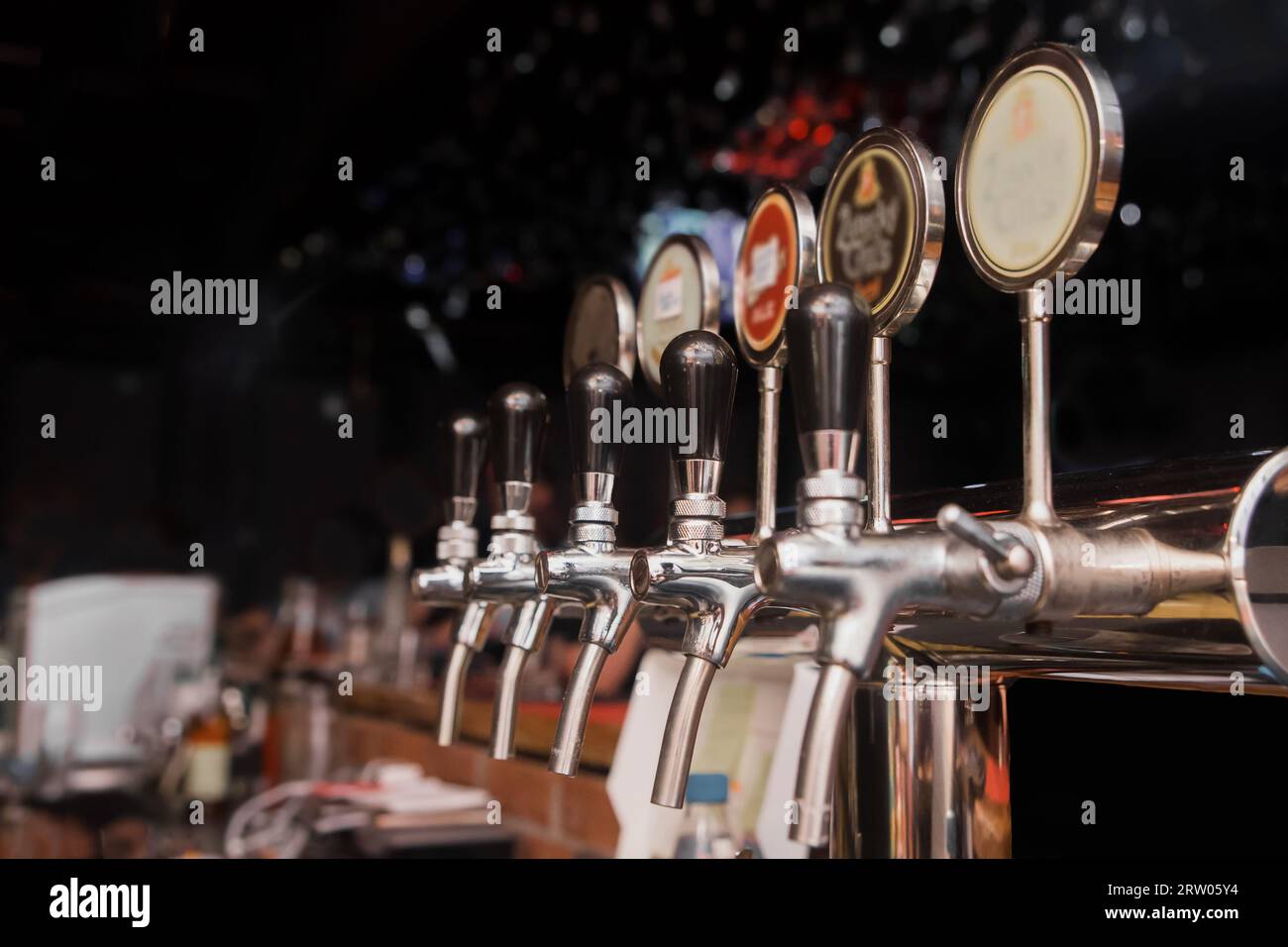 A line of taps of draft beer in the bar of the establishment, close-up ...