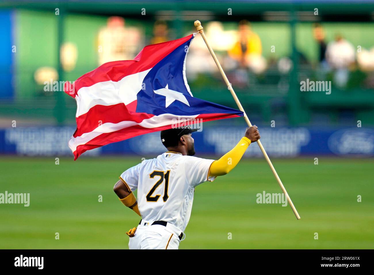 Pittsburgh Pirates right fielder Joshua Palacios carries the flag of ...