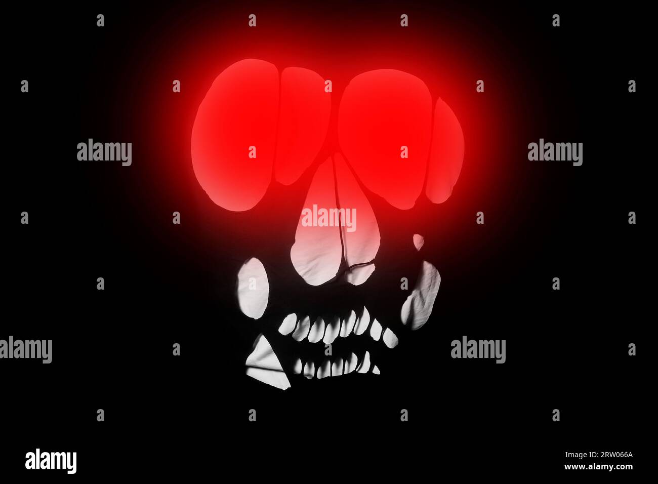 Scary frightening face red eyes and nose, teeth, white skull, black ...