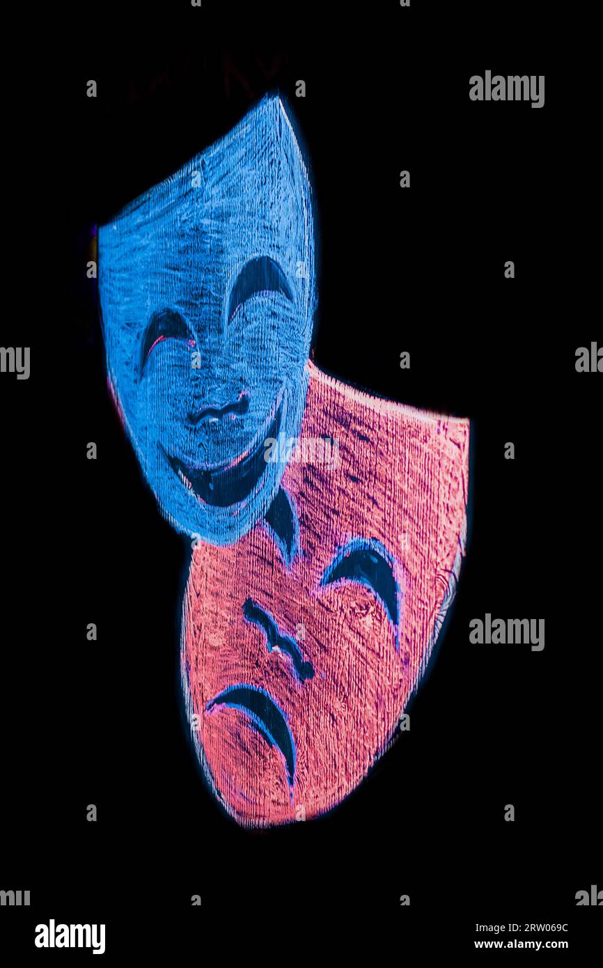 Masks show 2 colored masks sad and cheerful in the black background ...