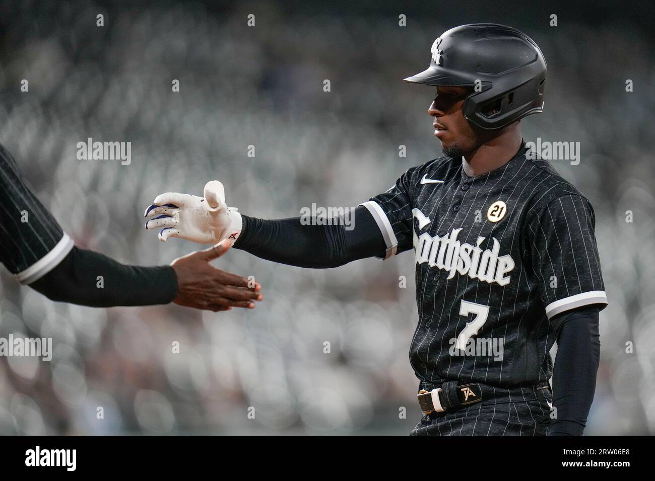Chicago White Sox's Tim Anderson, right, slaps hands with first base ...