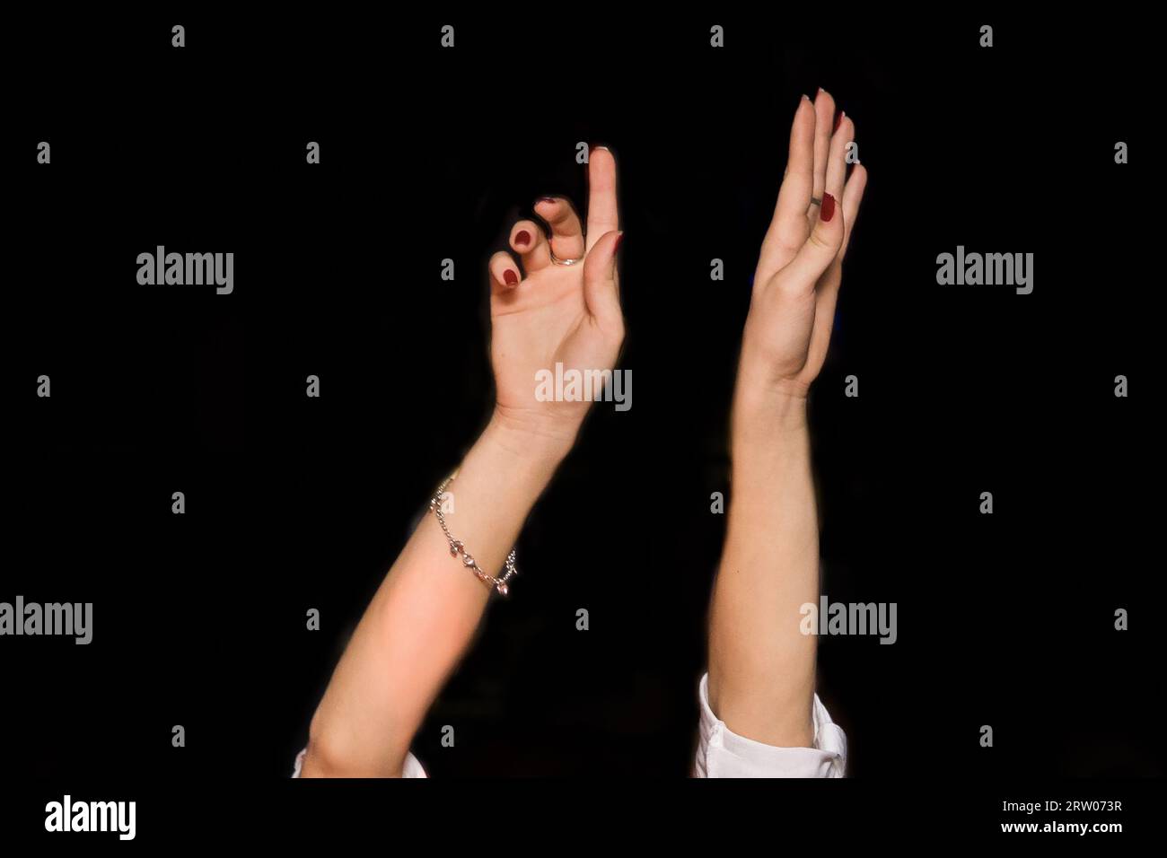 Women's hands up gesture of a girl's hand while dancing on a black ...