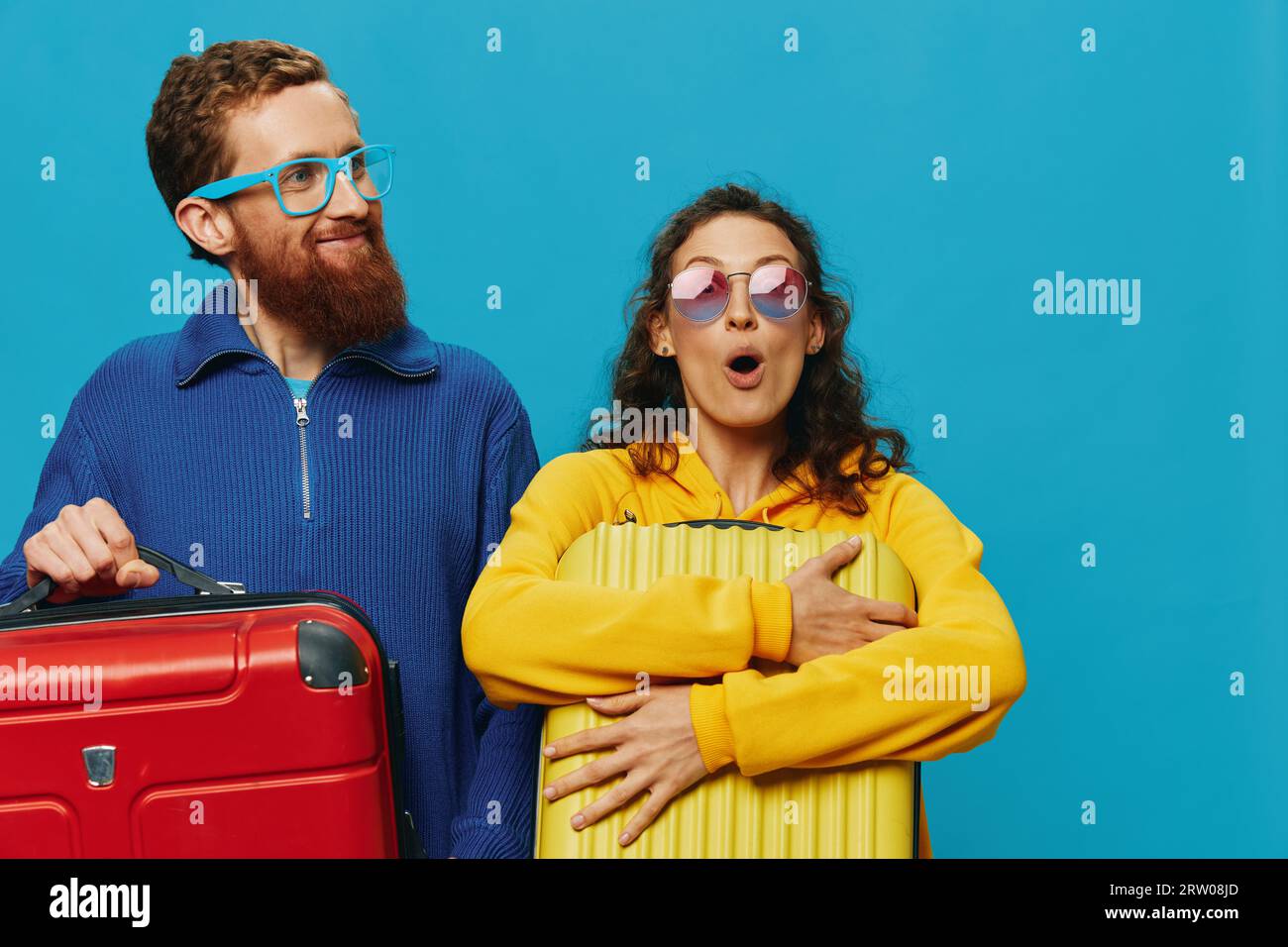 Woman and man smile suitcases in hand with yellow and red suitcase ...