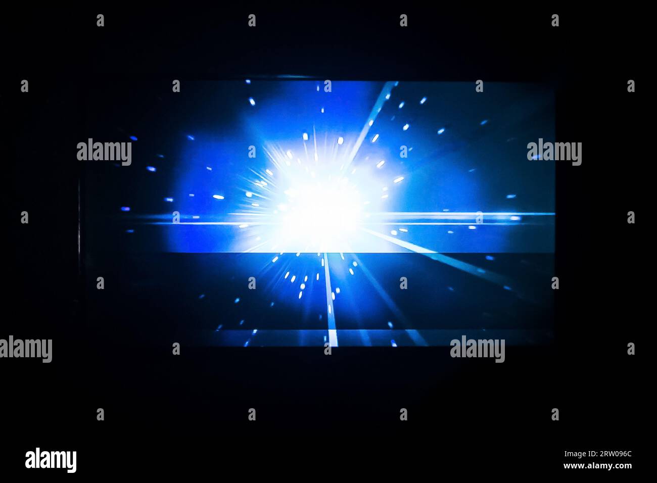 Bright white glare light spot at the end of the tunnel in darkness ...