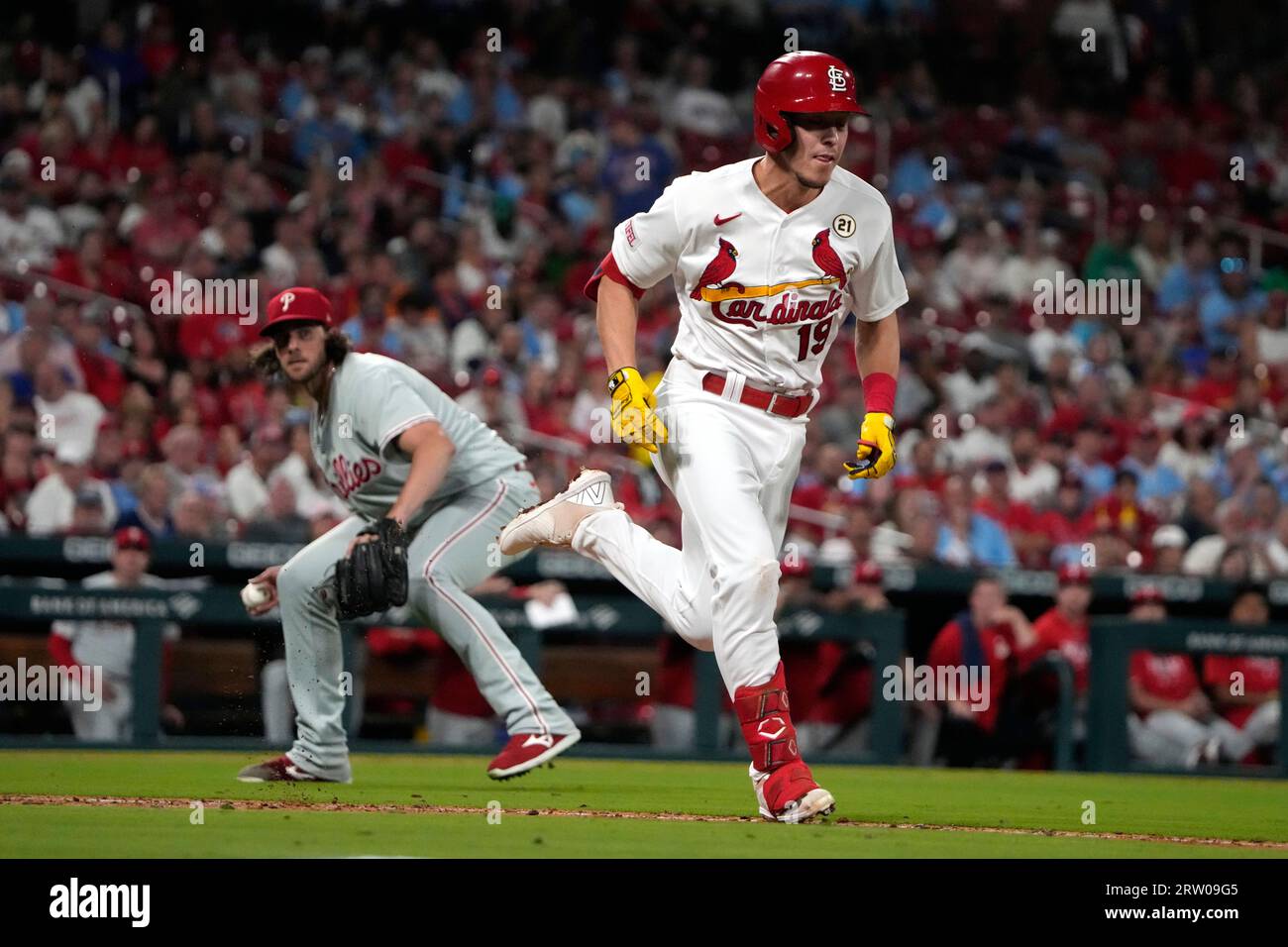 St. Louis Cardinals' Tommy Edman, right, reaches base on a throwing ...