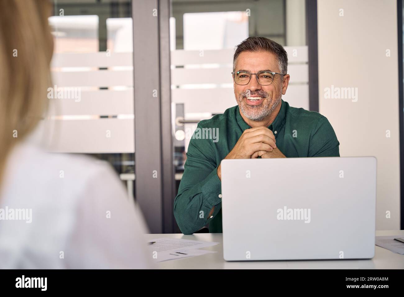 Smiling older business man hr having conversation at office meeting ...