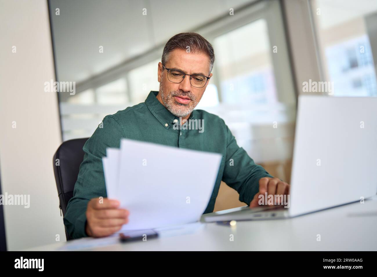 Middle aged business man executive using laptop checking financial ...