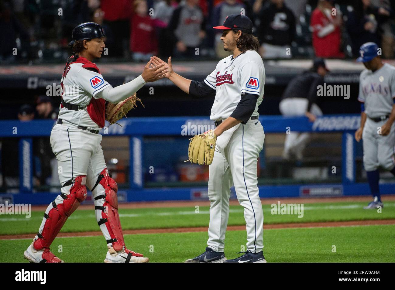Cleveland Guardians' catcher Bo Naylor, left, greets pitcher Eli Morgan ...