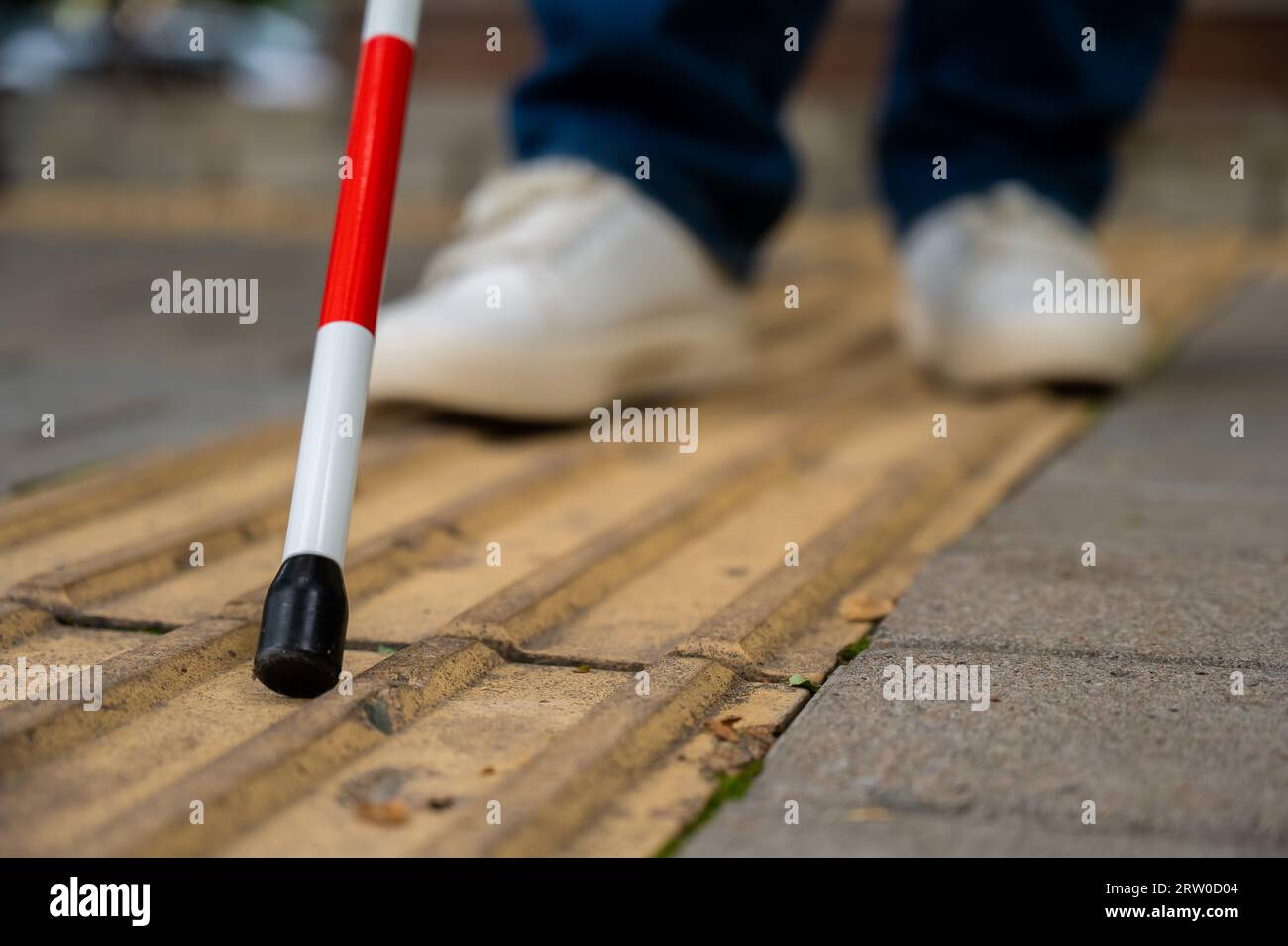 Person walking on tactile paving hi-res stock photography and images ...