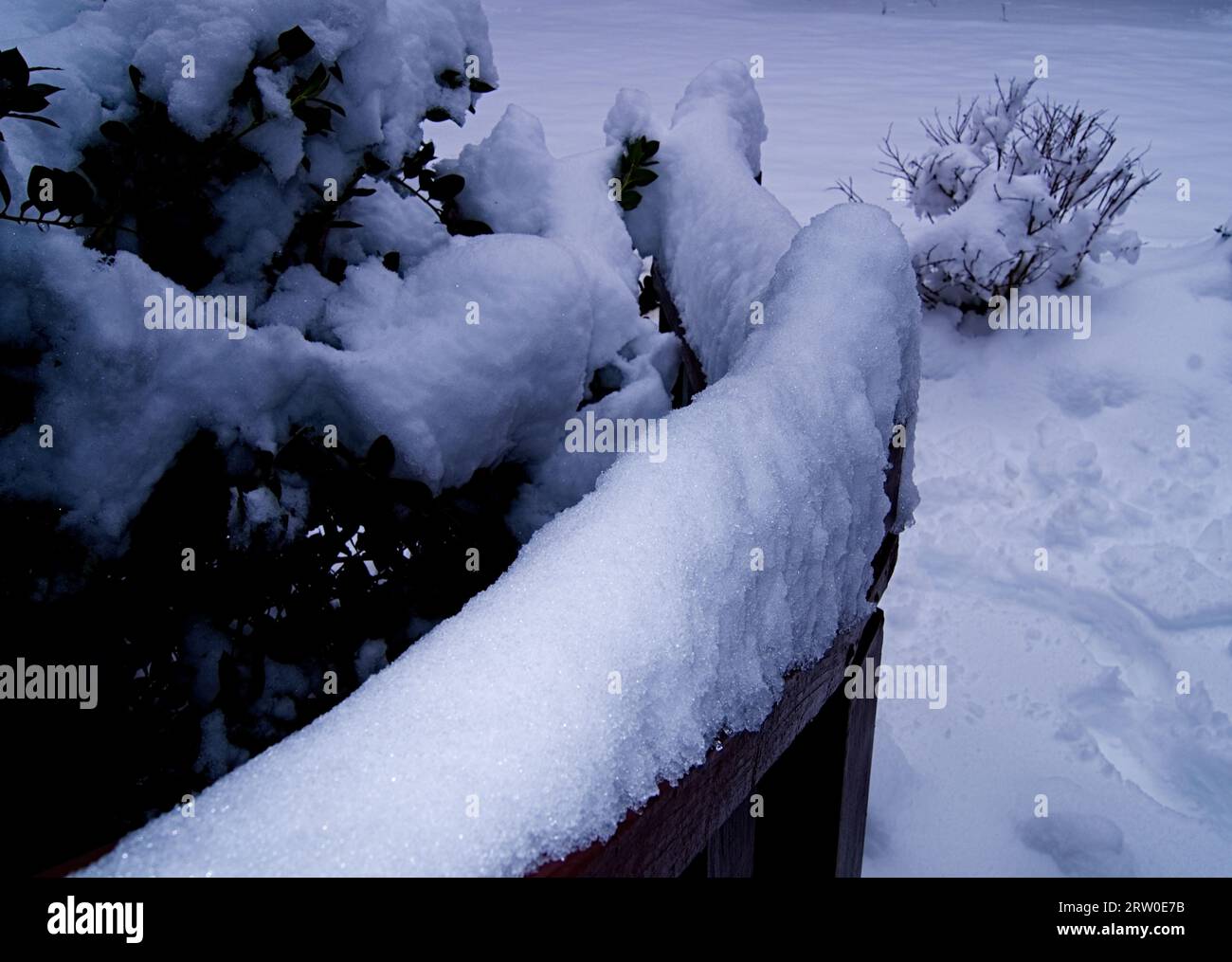 Snow covering a railing outside on a porch Stock Photo - Alamy
