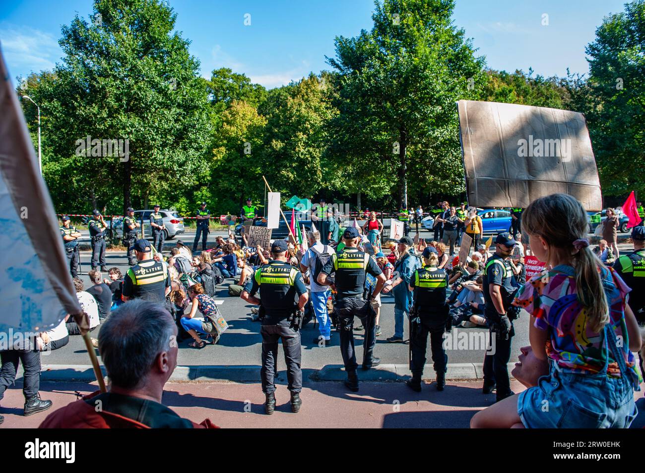 A man and a little girl are seen watching the blockade from one of the ...